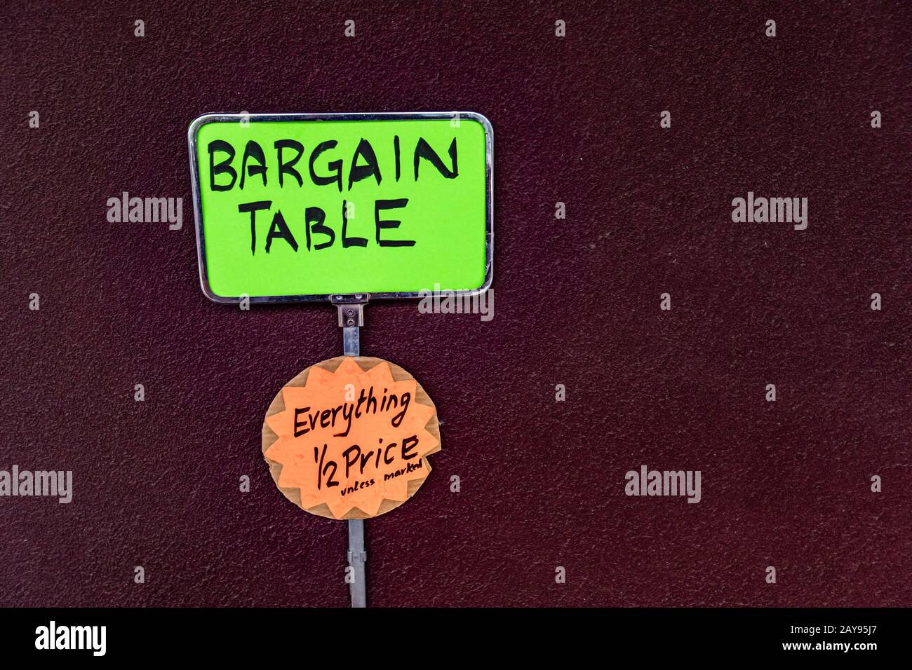 Hand written signs and price tags at the market. Yellow and orange fluo ...