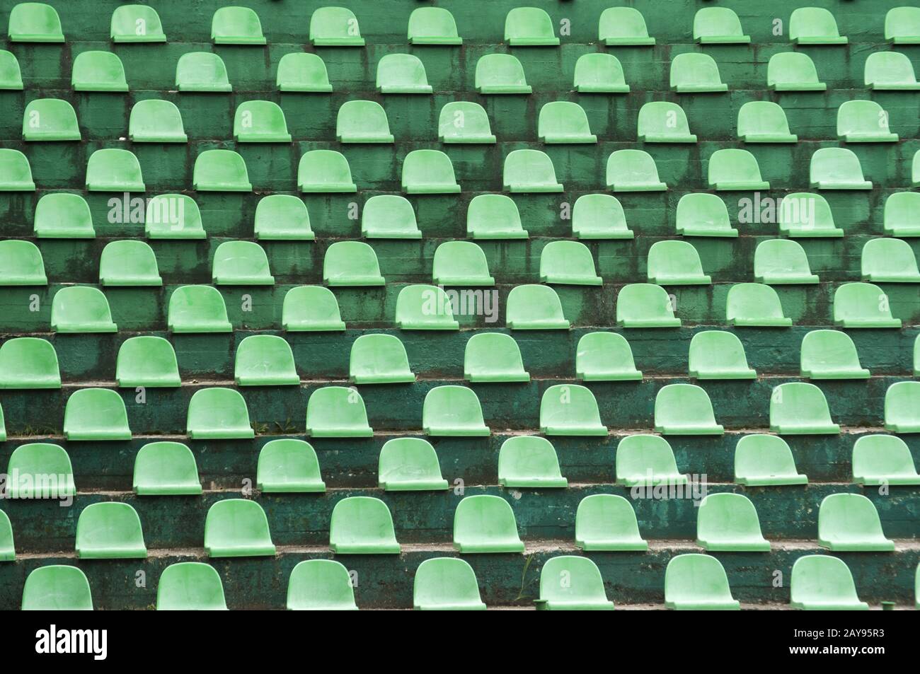 Empty green plastic spectators seats closeup on tennis court stand ...