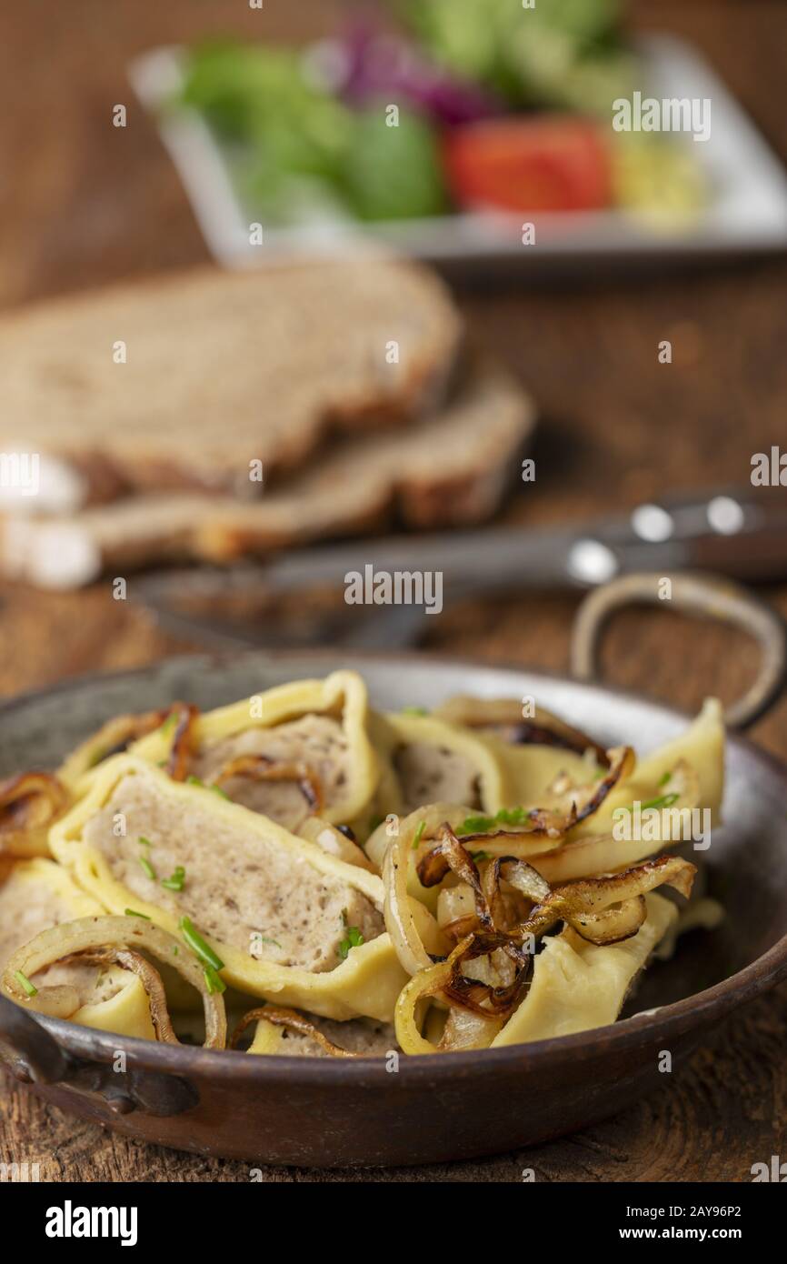 Swabian Maultaschen with onions in a pan Stock Photo - Alamy