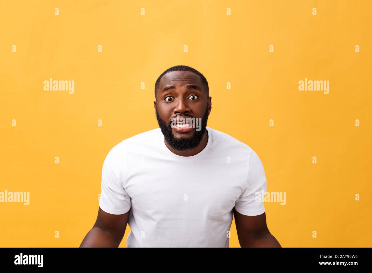 Portrait of african american man with hands raised in shock and ...