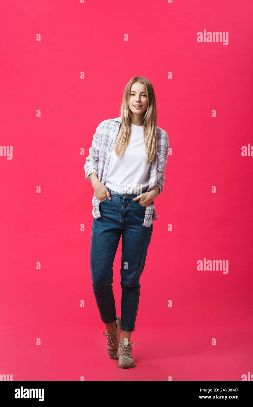 Full Length Young Beautiful Woman In Casual Cloth Standing Over Pink