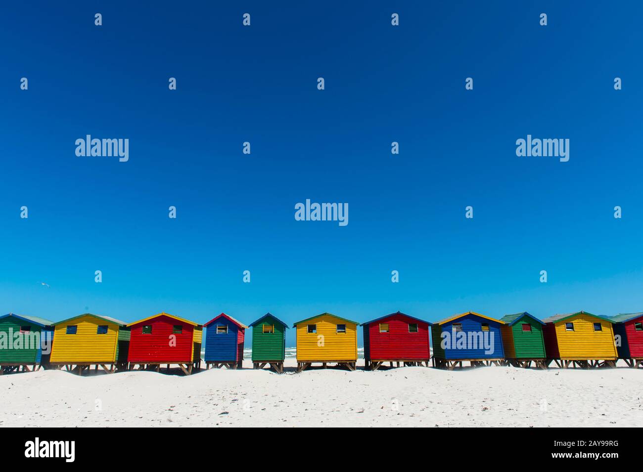 View of colorful beach changing huts on the beach at Muizenberg, a ...
