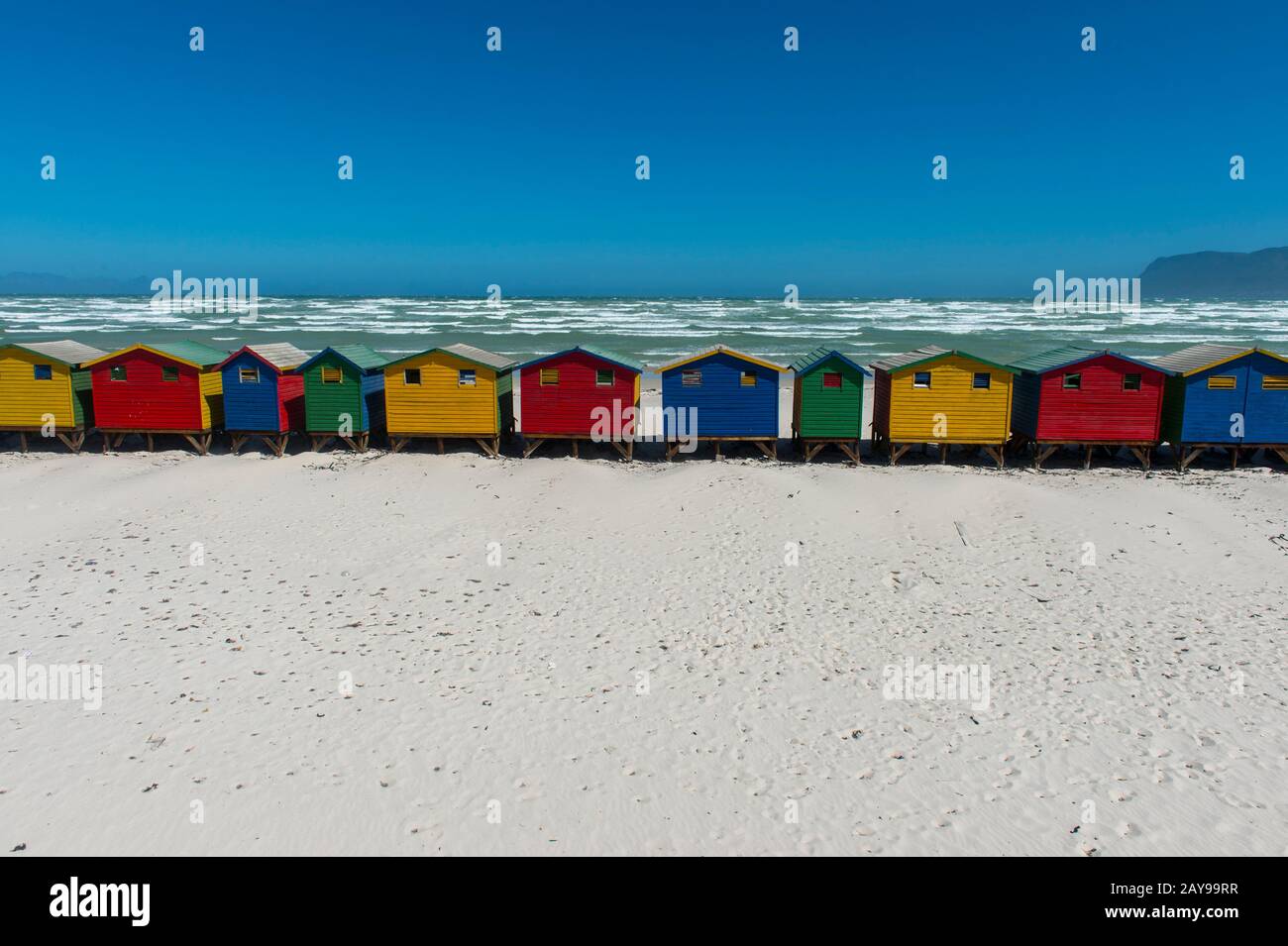 View of colorful beach changing huts on the beach at Muizenberg, a ...