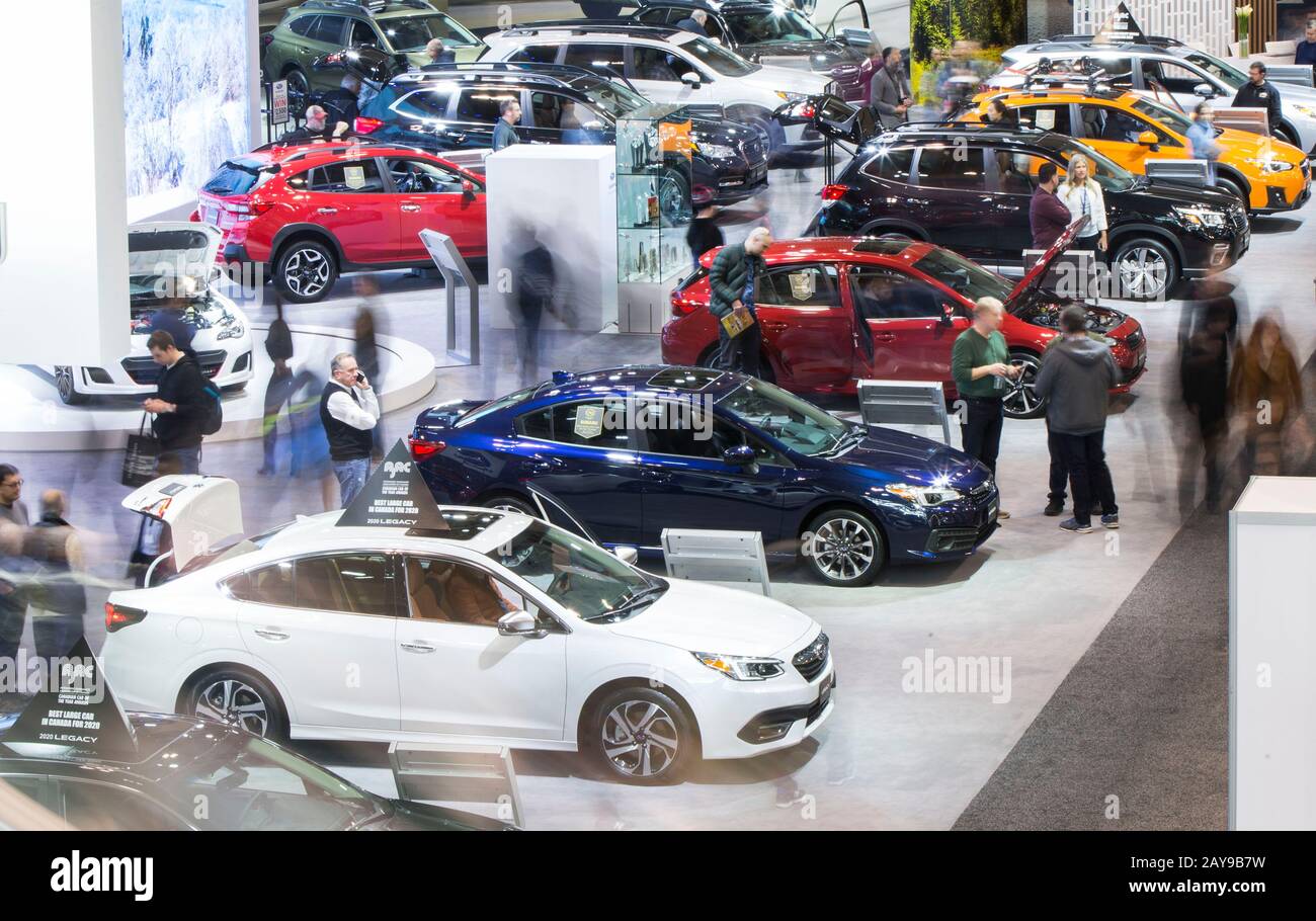 Toronto, Canada. 14th Feb, 2020. Visitors look at vehicles during the ...