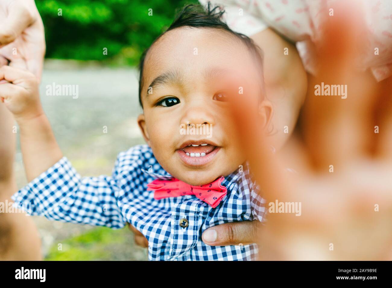 Closeup view of a baby boy reaching for the camera Stock Photo - Alamy