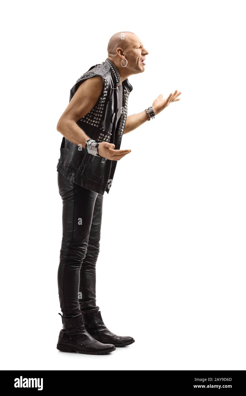 Full length profile shot of an angry punk in leather clothes gesturing ...