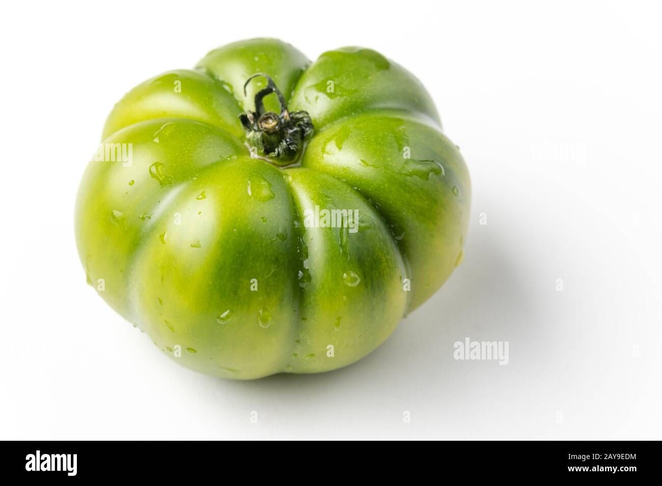 fresh green tomato on white background Stock Photo - Alamy