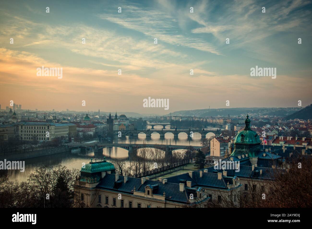 Prague bridges panorama during mist fog morning sunrise warm light red ...