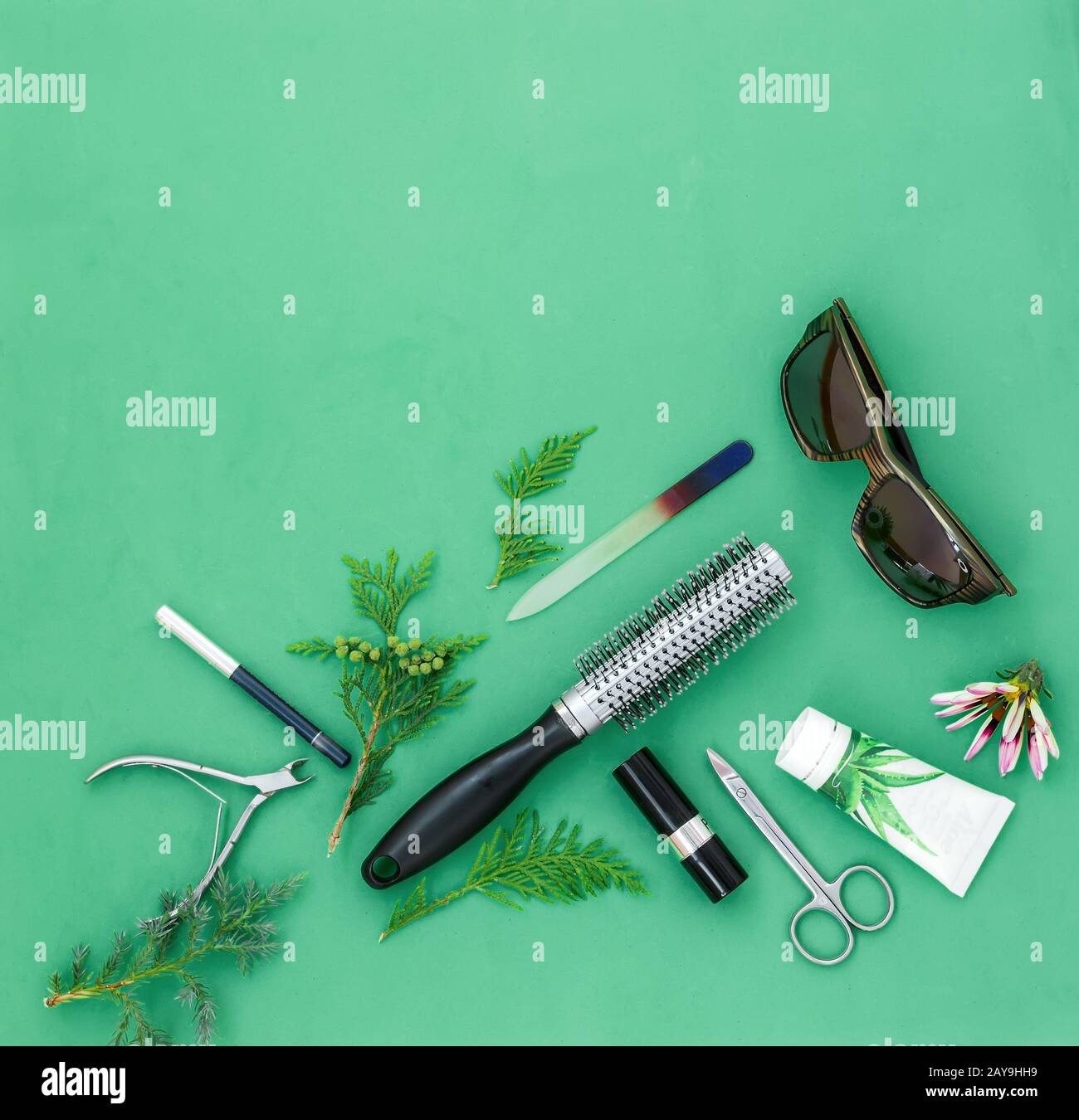 Cosmetics items on a light green background Stock Photo - Alamy