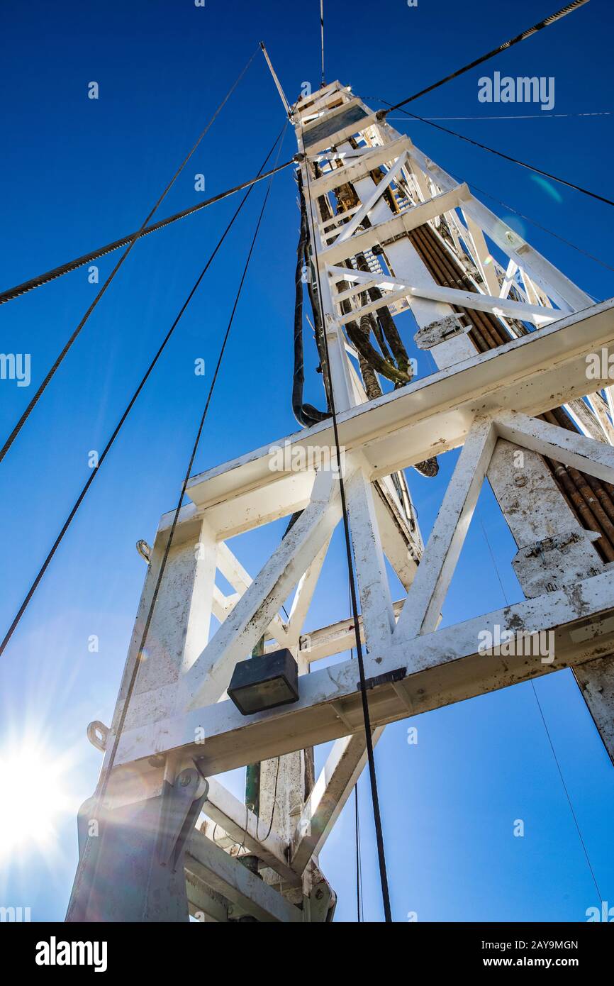 Drilling onboard a drill rig against a sun flare Stock Photo - Alamy