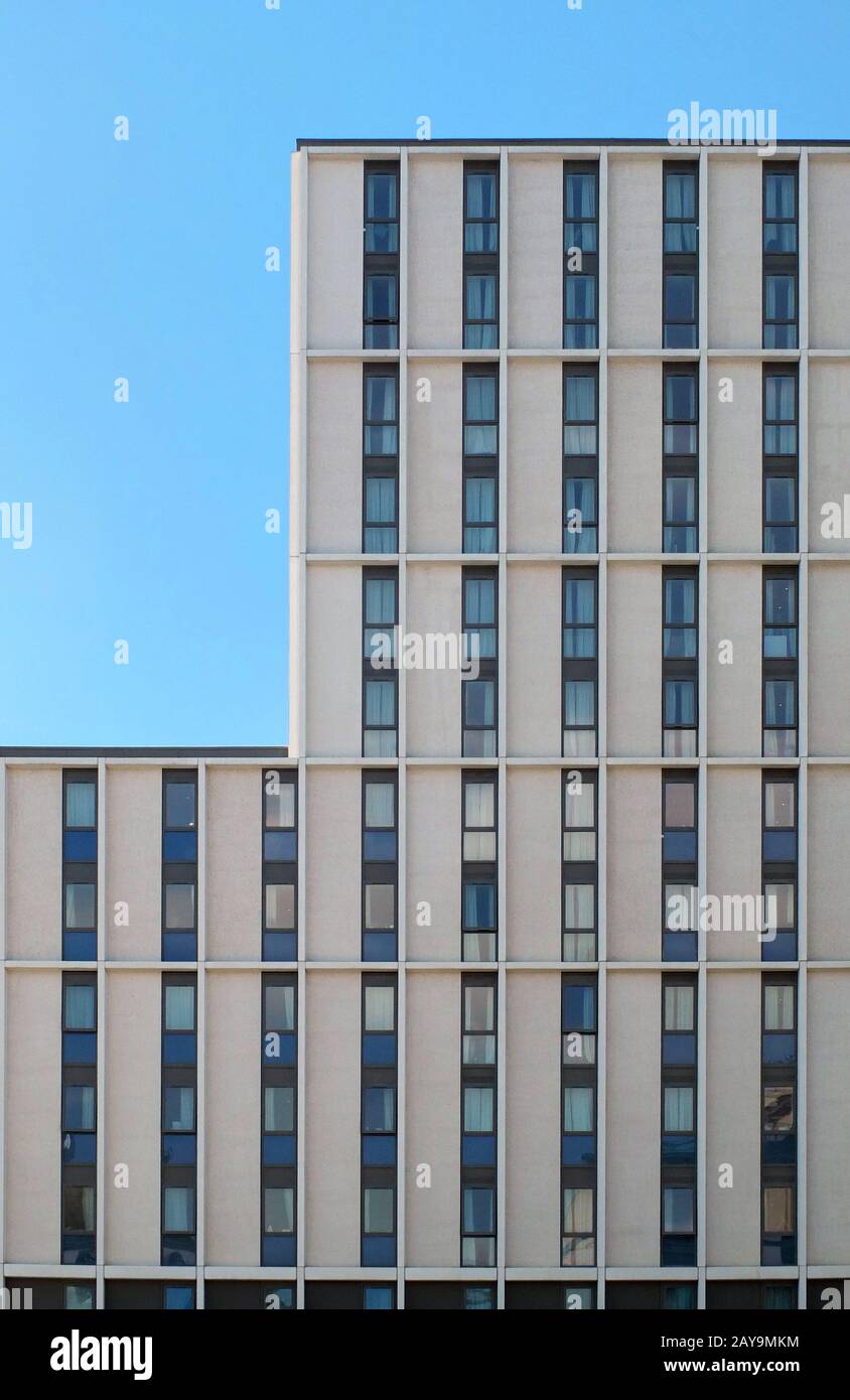 white modern concrete highrise concrete building with geometrical ...