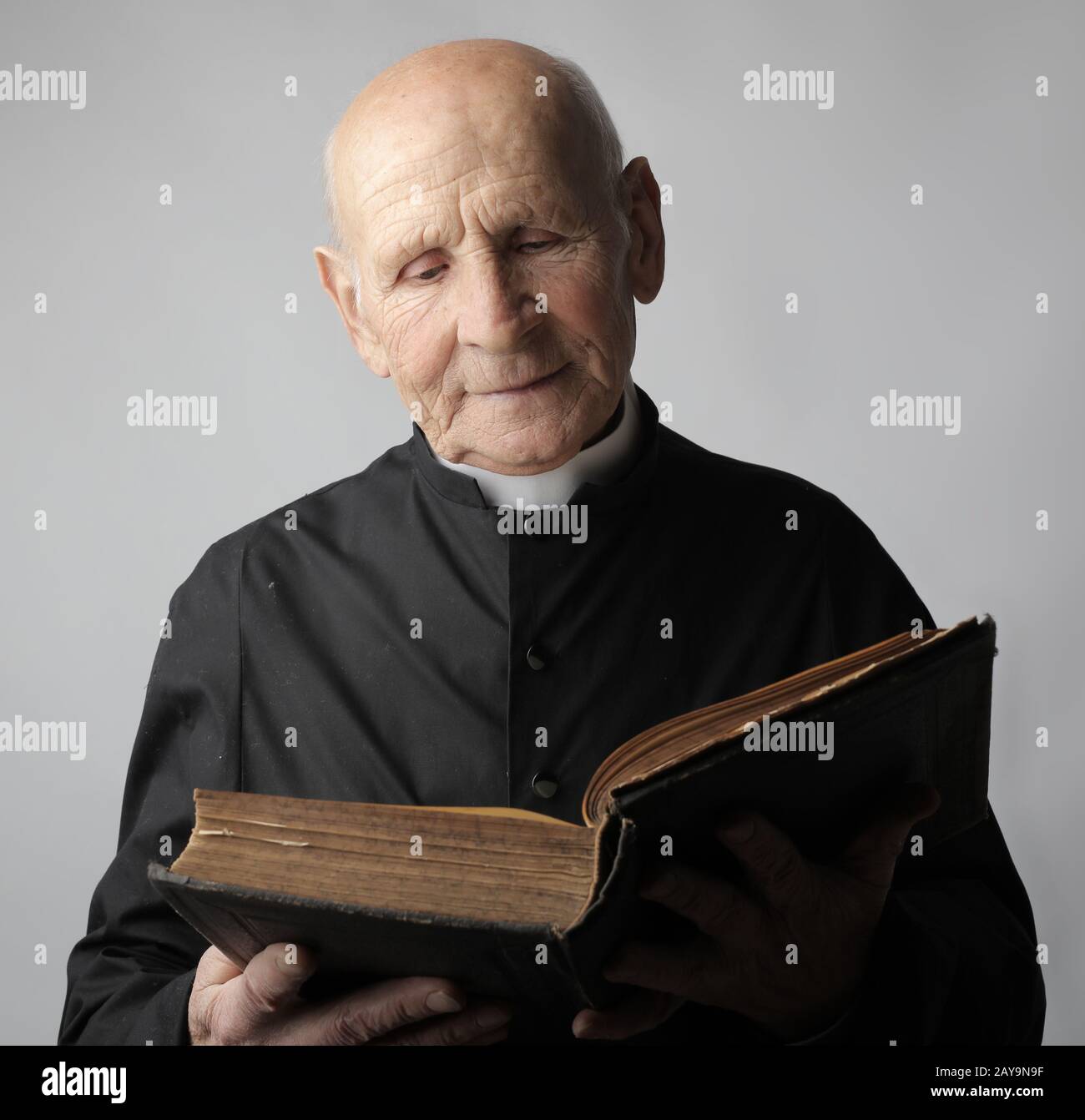 portrait of a old priest with bible Stock Photo - Alamy