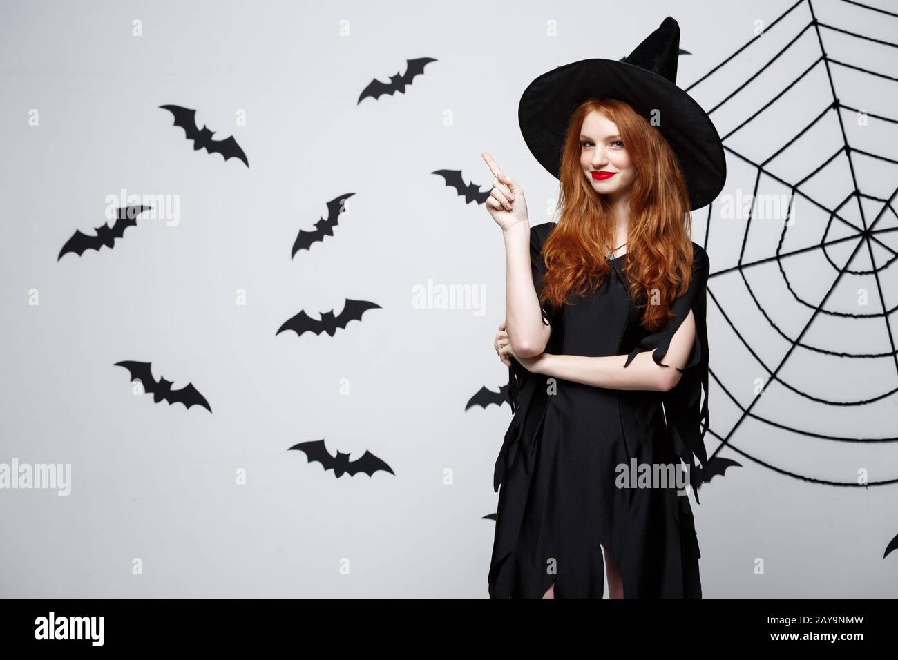 Halloween witch concept - Happy Halloween Witch pointing finger on side ...