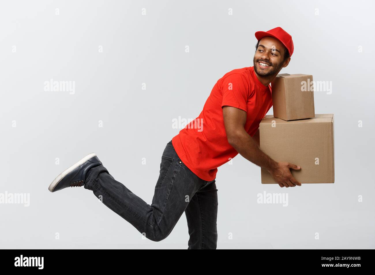 Delivery Concept - Handsome African American delivery man rush running ...