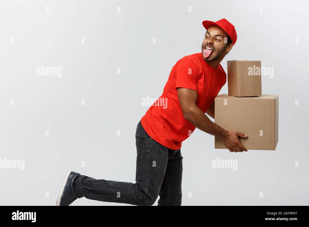 Delivery Concept - Handsome African American delivery man rush running ...