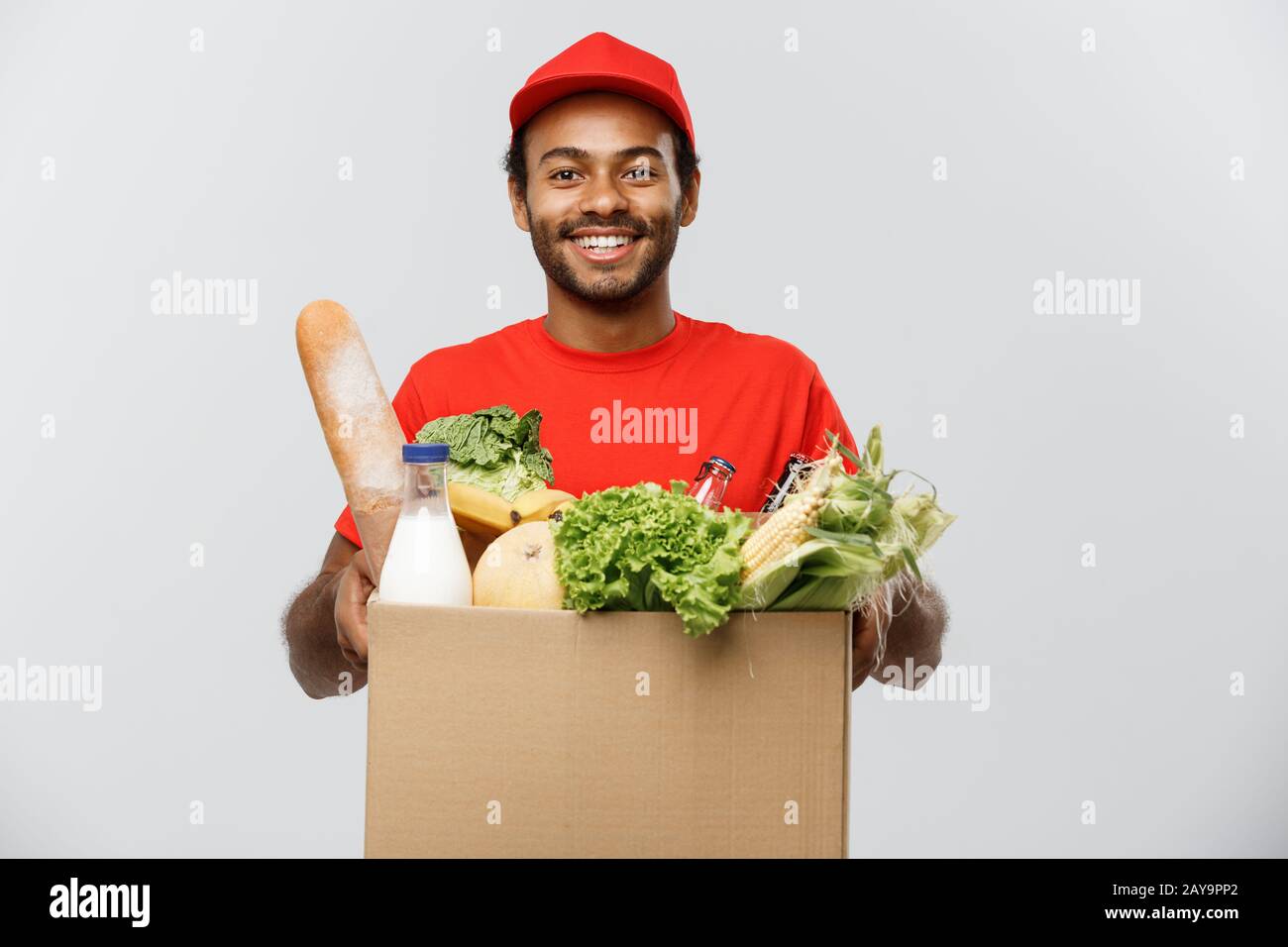 Delivery Concept - Handsome African American delivery man carrying ...