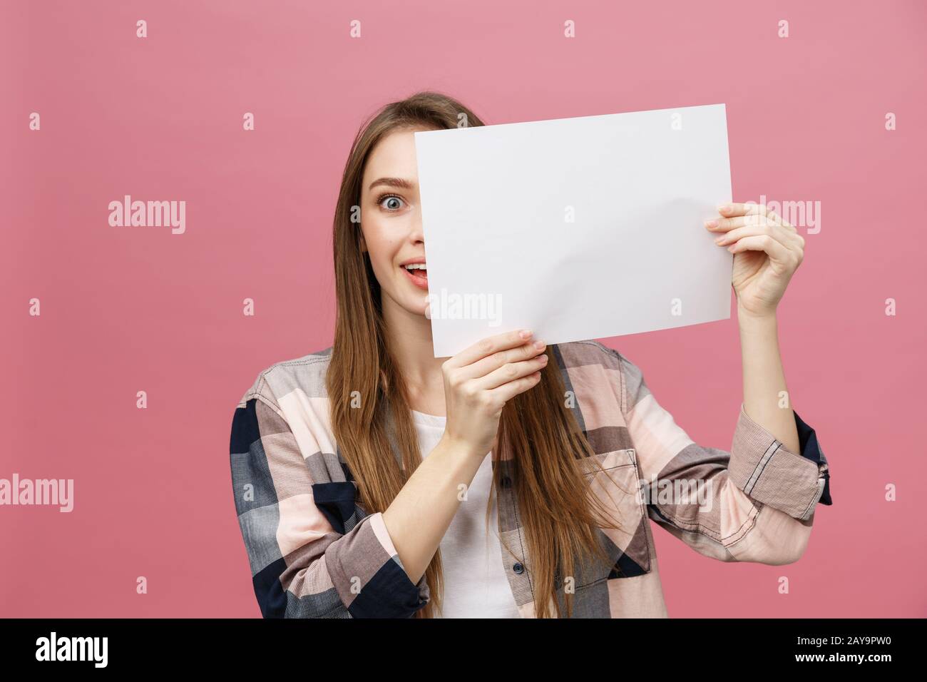 Young caucasian woman holding blank paper sheet over isolated ...