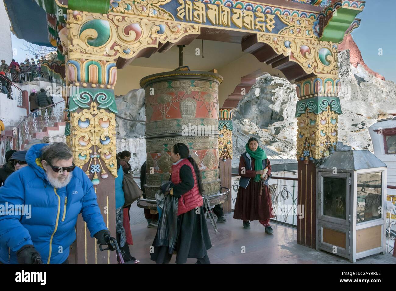 Festival goers turn a large prayer wheel, Spituk Gompa, Leh district ...
