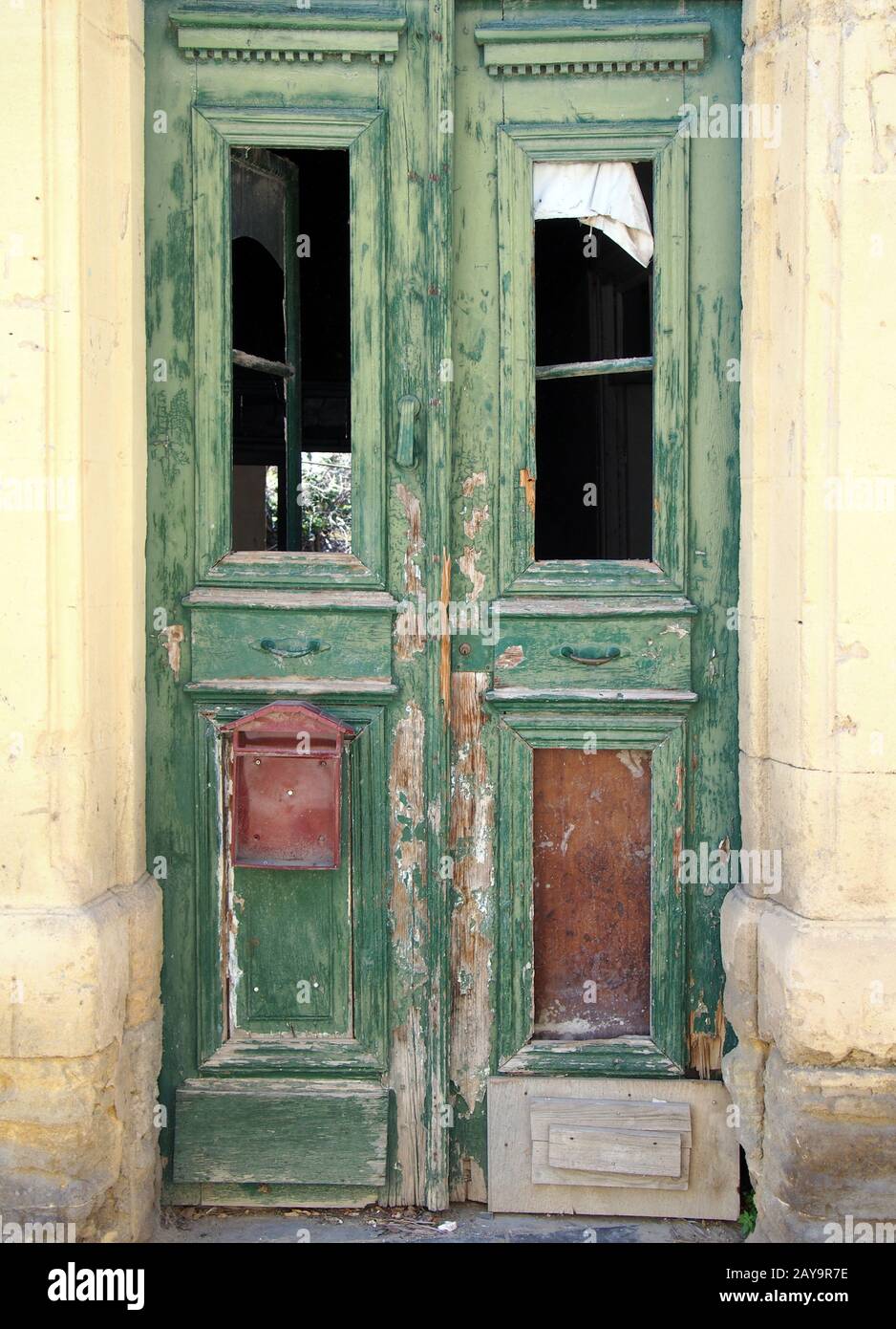 broken old double green doors in an abandoned derelict house with ...