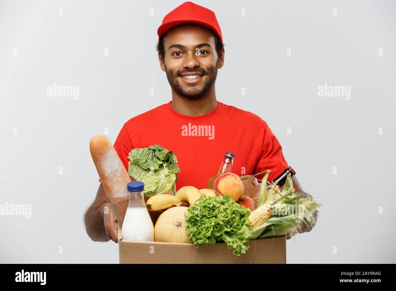 Delivery Concept - Handsome African American delivery man carrying ...