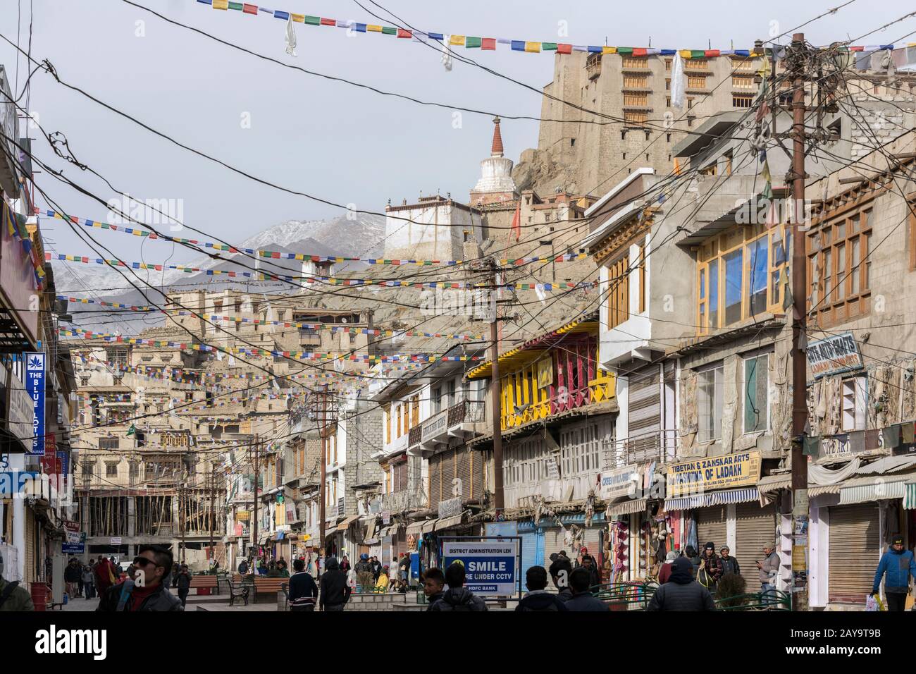 Bazaar Road with prayer flags and electric wires, looking towards Leh ...