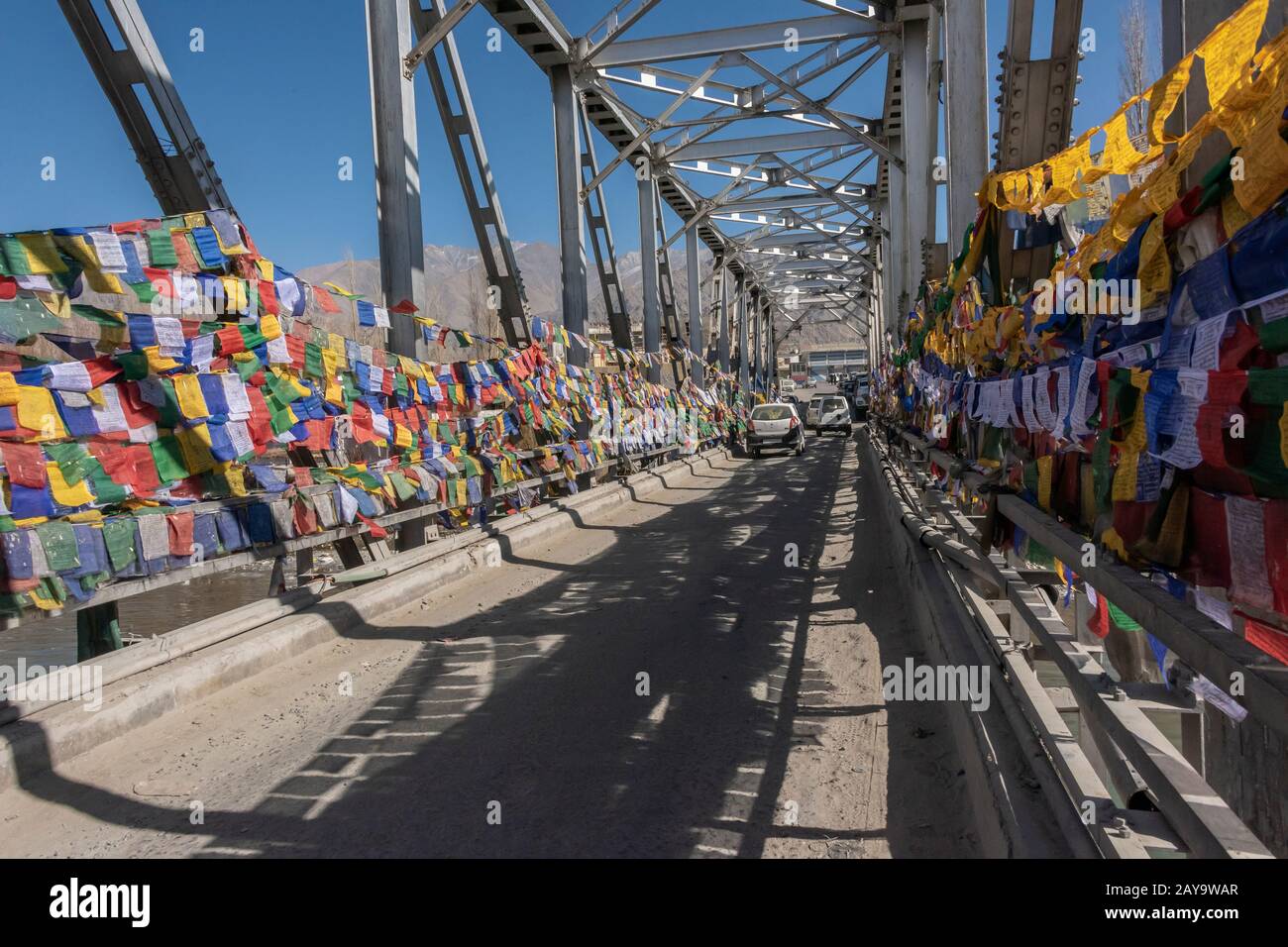 Crossing the Chuckhot Rd bridge with prayer flags and shadows, Leh ...