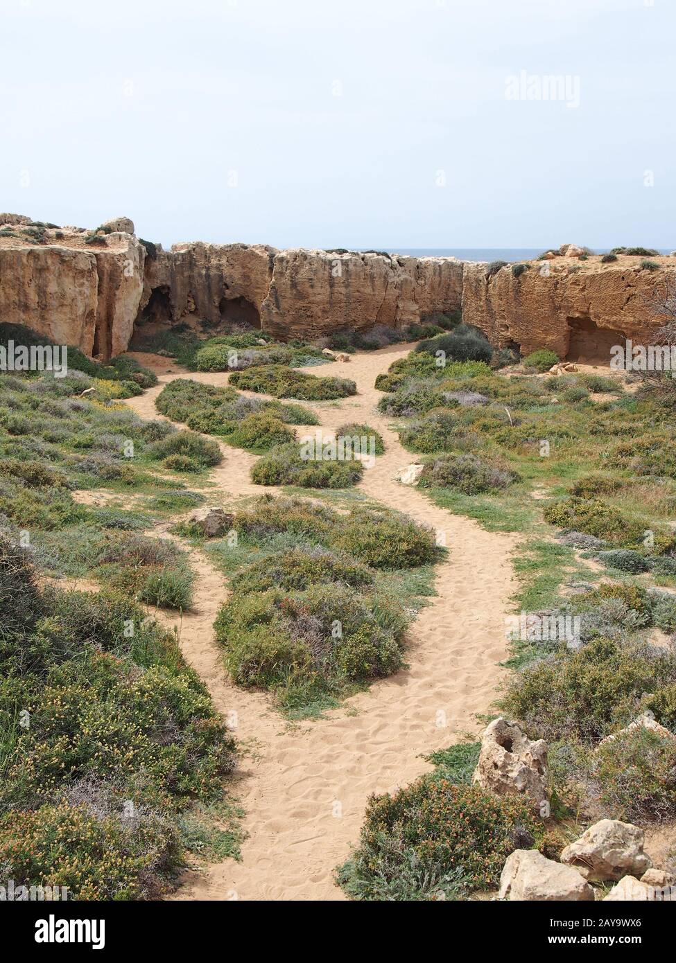 path leading to caves in the rock face near the sea at the tomb of the ...