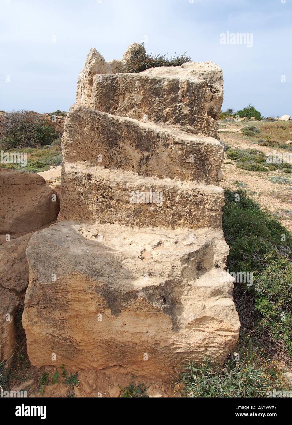 exposed carved stone tomb with steps in the tomb of the kings area in ...