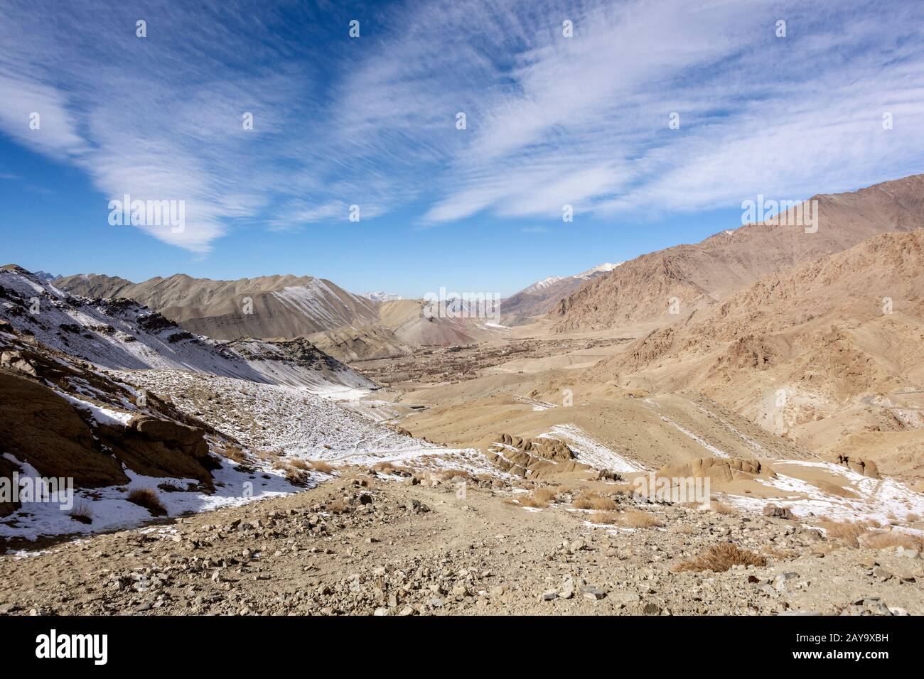 High valley, blowing clouds and small village near Fotu La, Ladakh ...