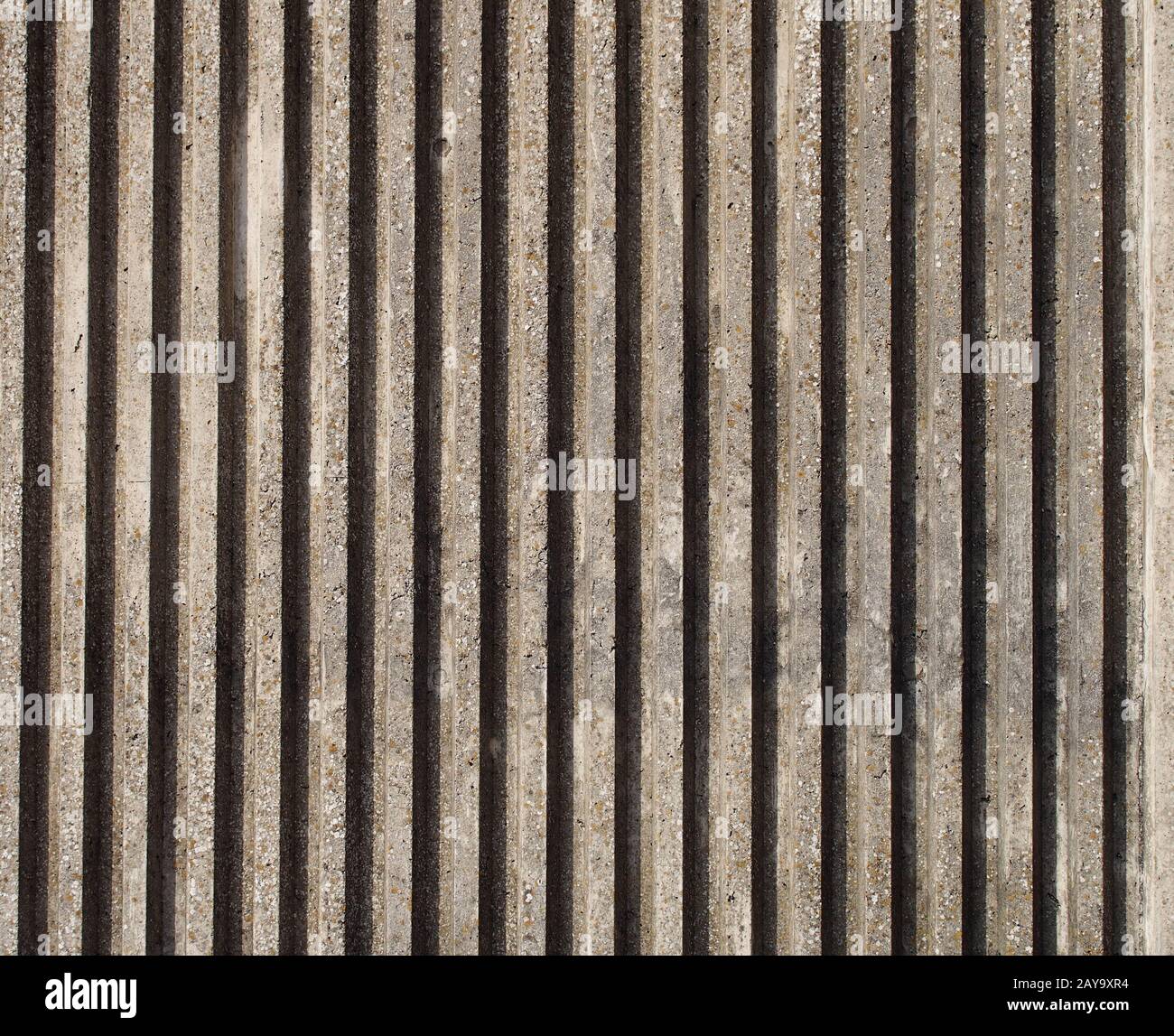 textured cast concrete wall with vertical lines and stripes Stock Photo ...