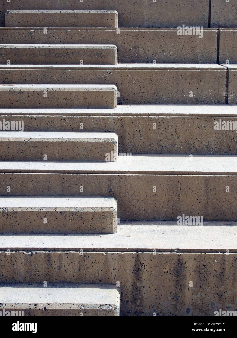 Modern outdoor concrete ascending steps with raised area for seating in ...