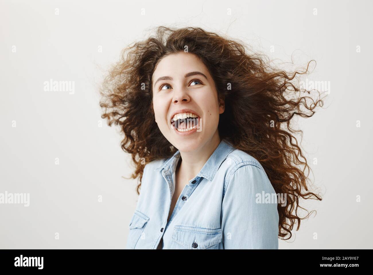 Portrait Of Beautiful Cheerful Redhead Girl With Curly Hair Smiling