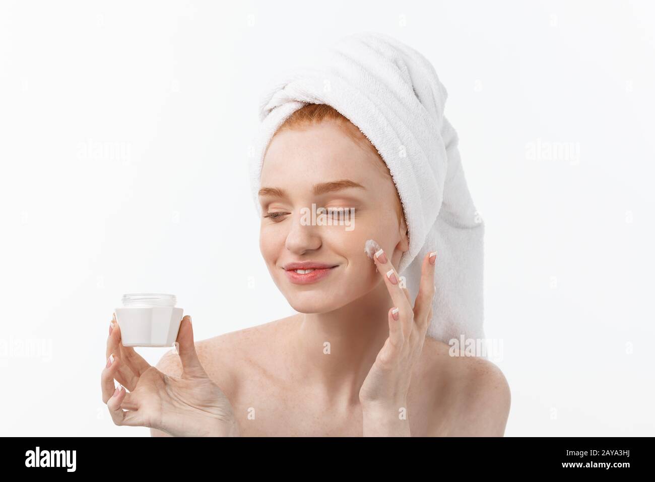 beautiful model applying cosmetic cream treatment on her face on white Stock Photo - Alamy