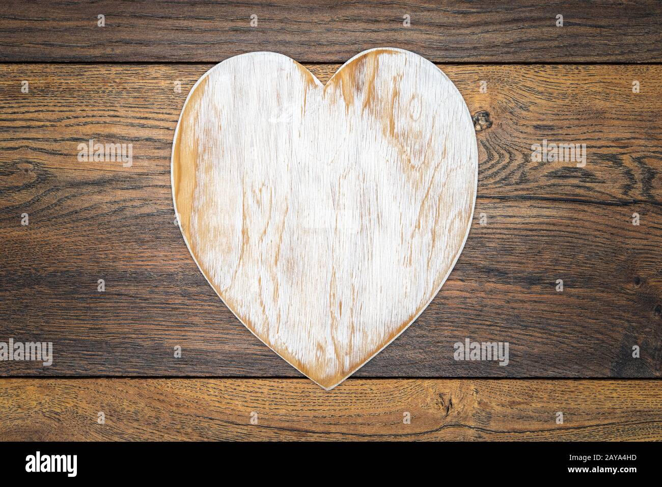 Large white wooden hart isolated on vintage oak Stock Photo - Alamy