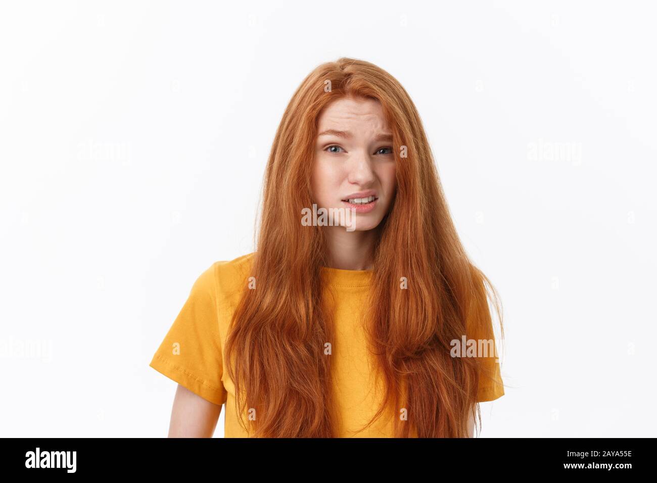 Happy cheerful young woman wearing her red hair looking at camera ...