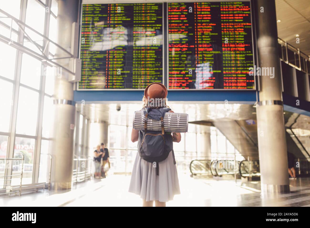 Theme travel public transport. young woman standing with back in dress ...