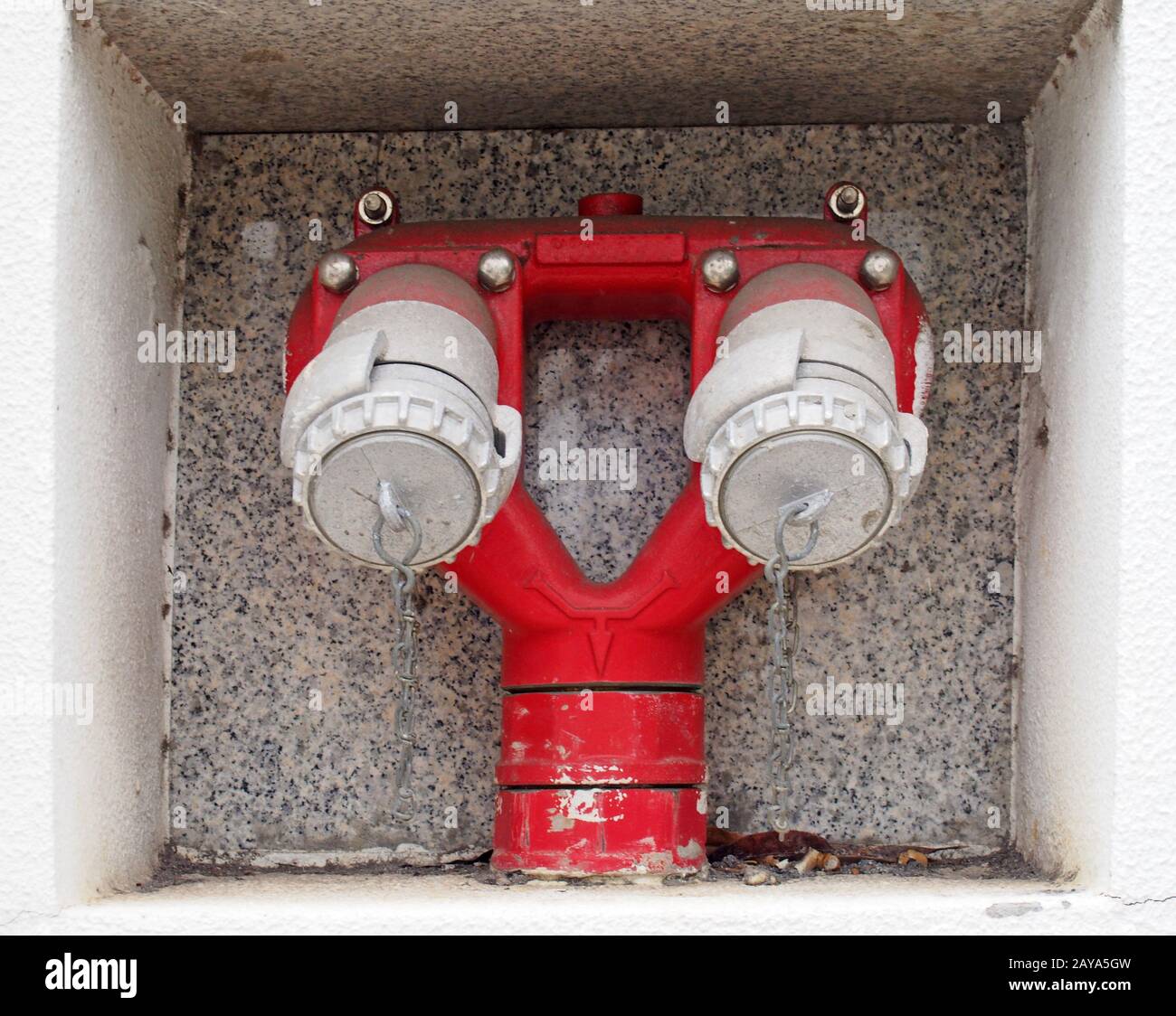 close up of a red double emergency outdoor fire hydrant inset into the ...