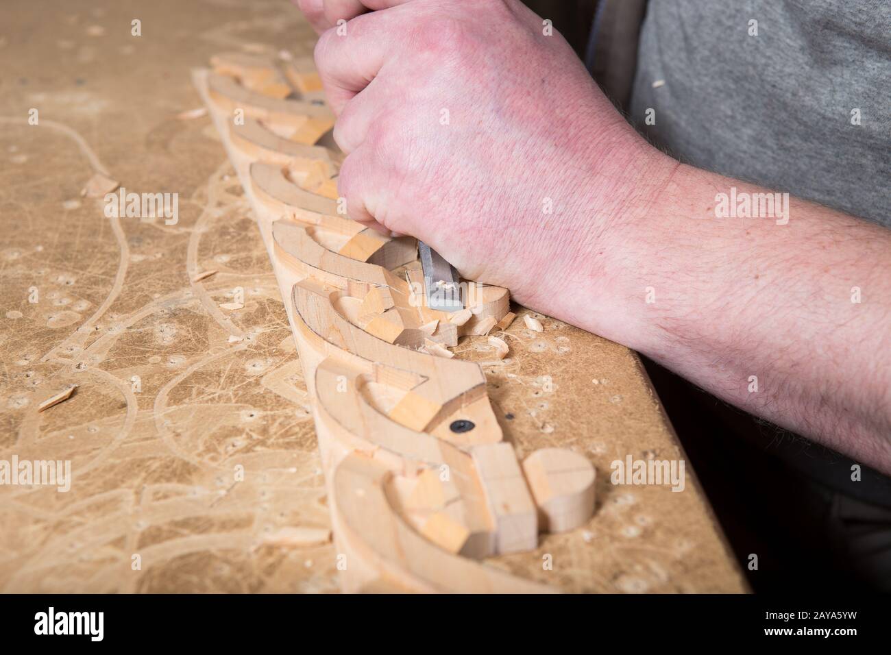woodcarver creates a furniture ornament. Woodcarver's hands, chisels ...