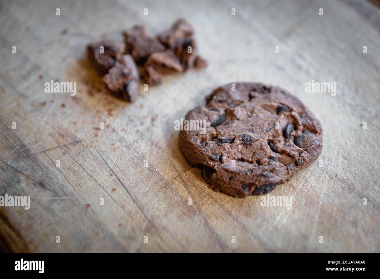 Broken chocolate chip cookies. Cookies broken in pieces with crumbs ...