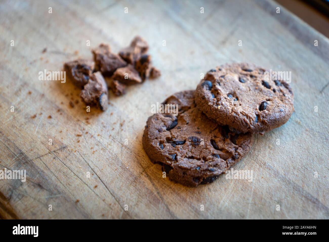 Broken chocolate chip cookies. Cookies broken in pieces with crumbs ...