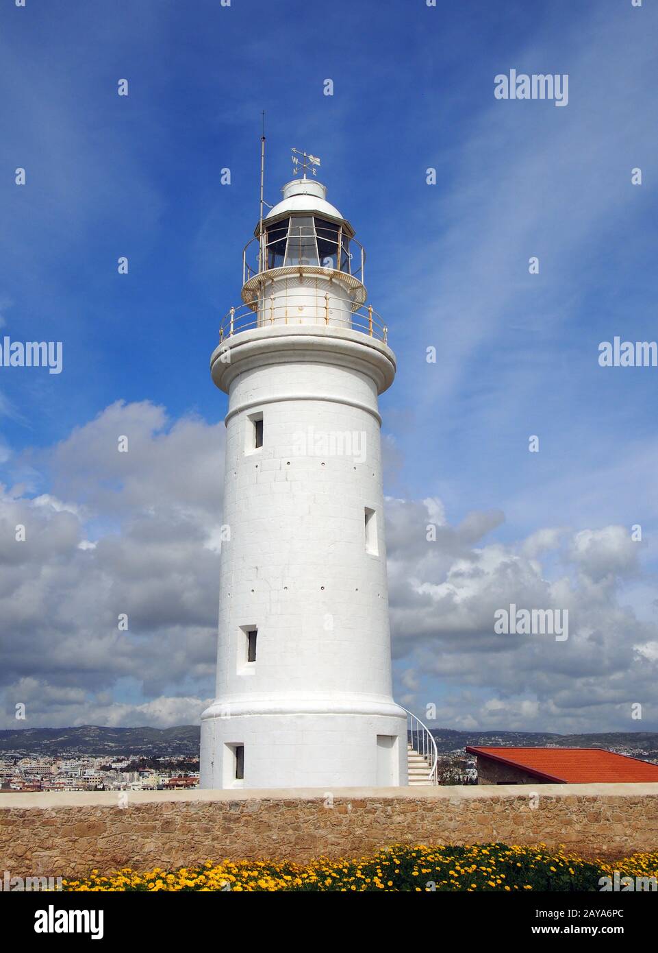 the famous historic white lighthouse in Paphos Cyprus with bright blue ...