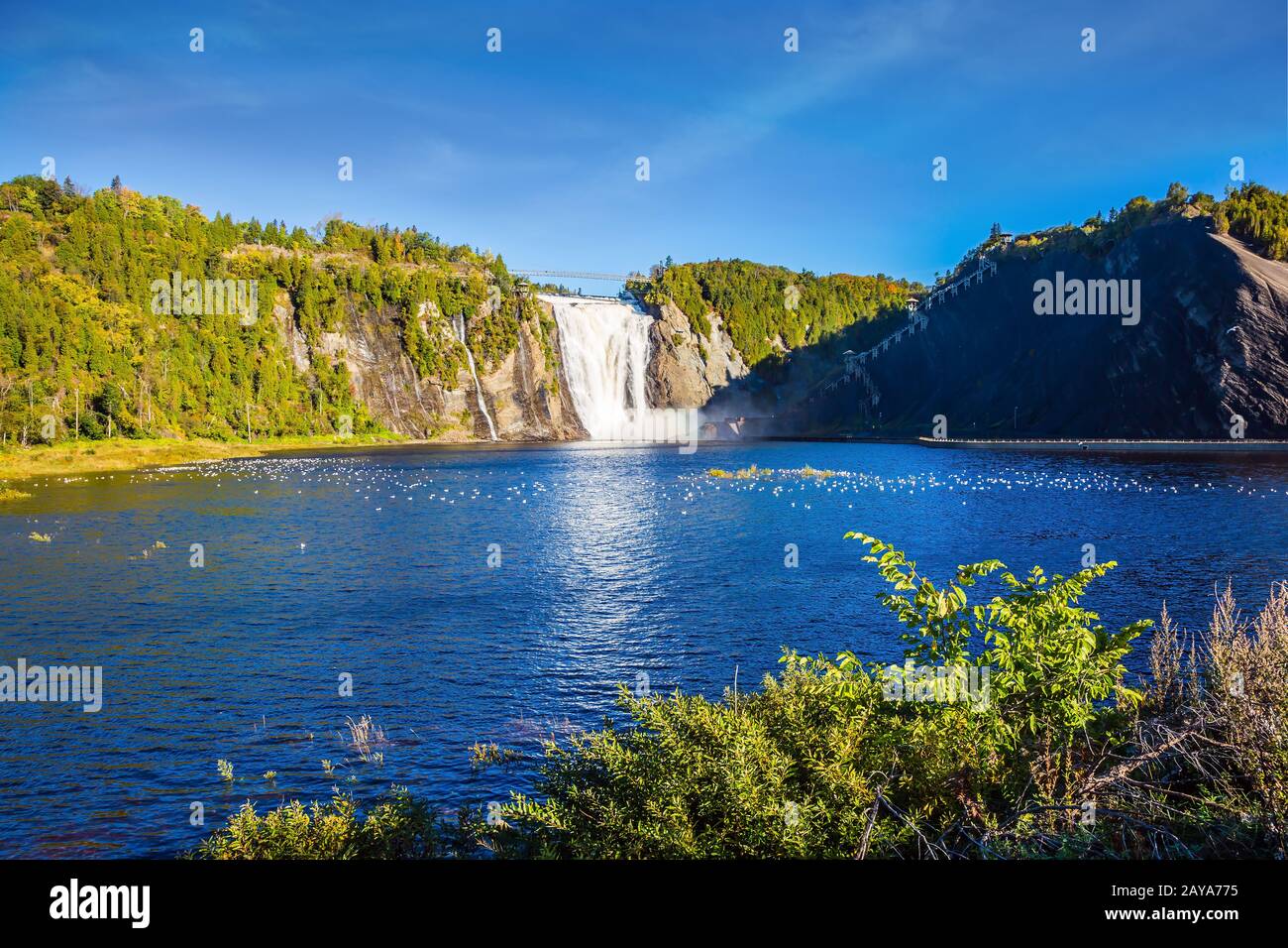 The vast blue lake and waterfall Stock Photo - Alamy