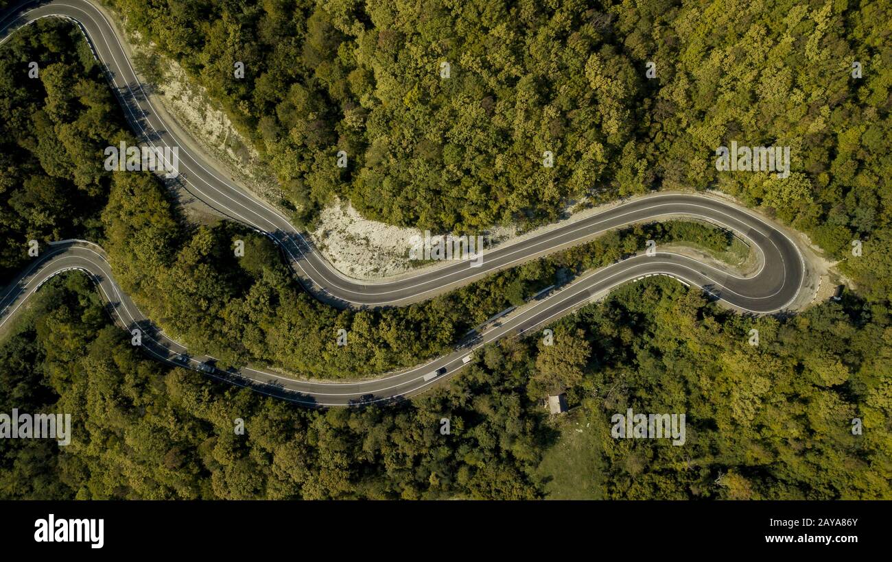 Winding road in forest, aerial drone view, road trip concept. Birds eye ...
