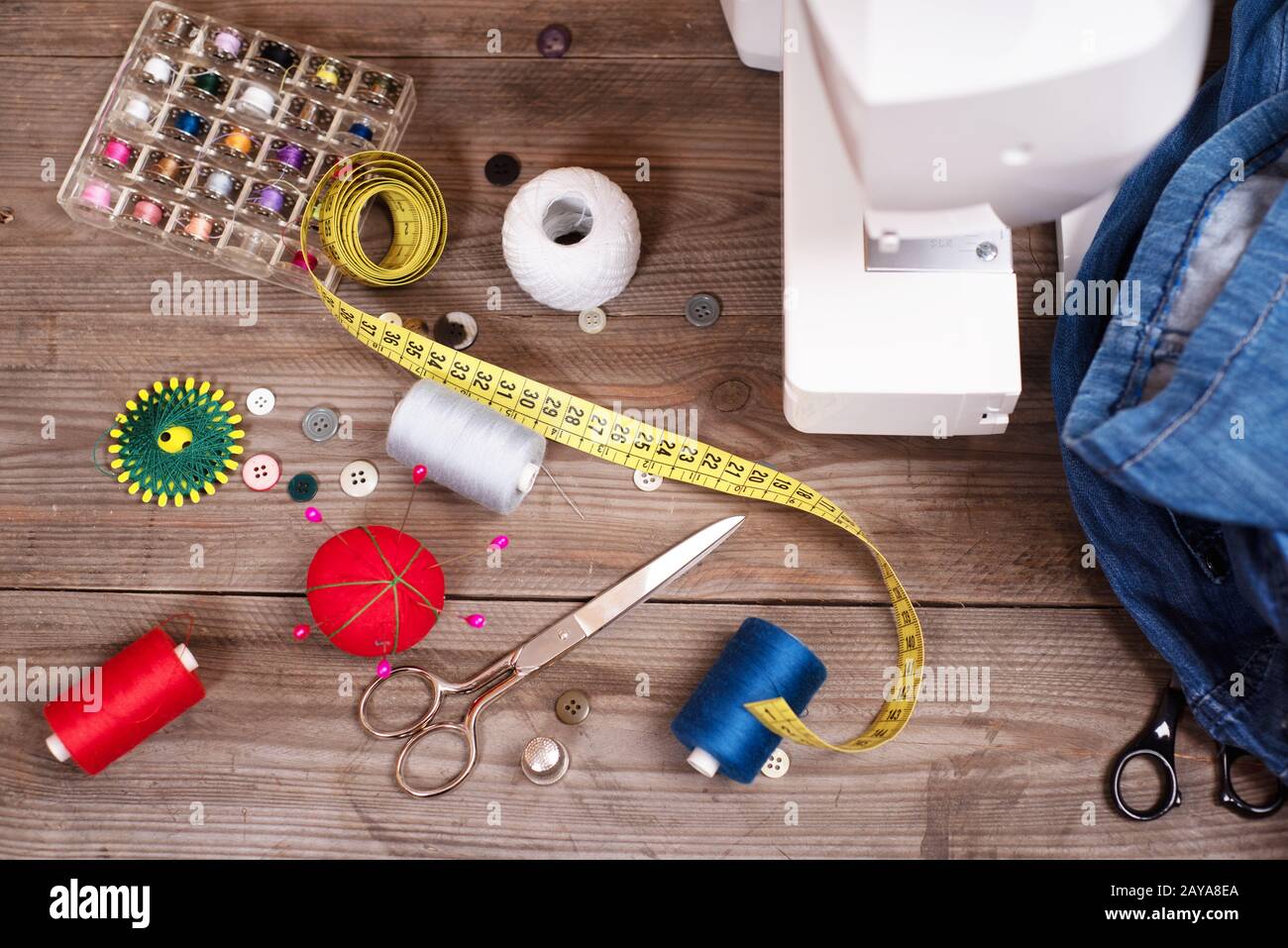 Seamstress or tailor background top view with jeans, sewing tools ...