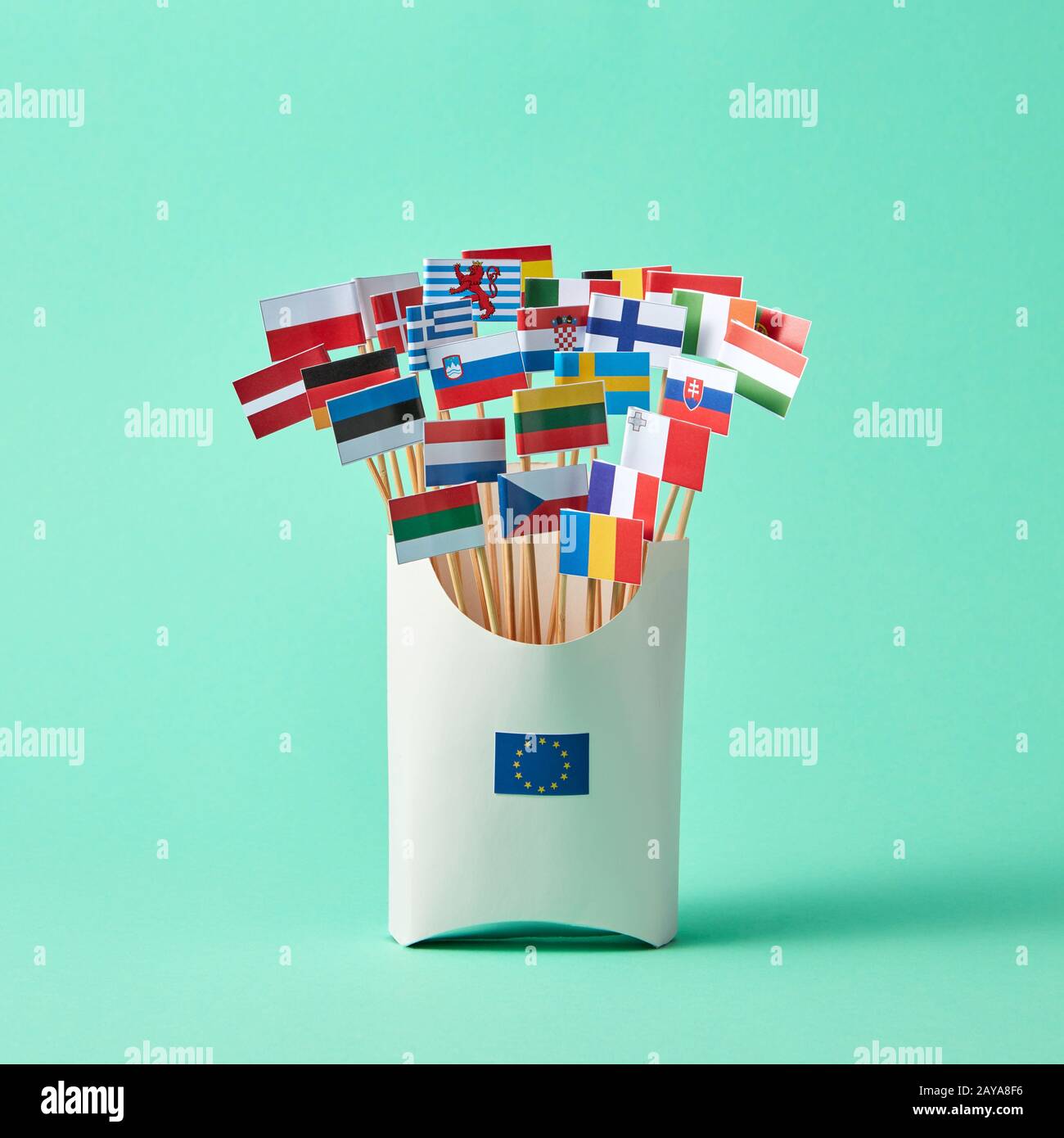 Set of different paper flags in cardboard box decorated with EU sign on ...