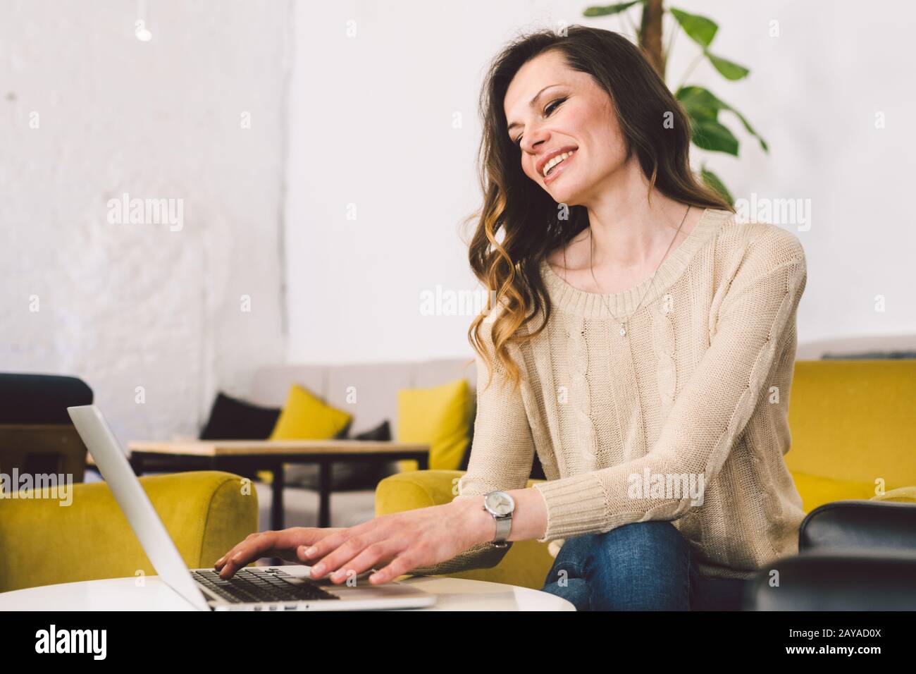 Young middle aged Caucasian woman with long hair. Casual clothes using ...