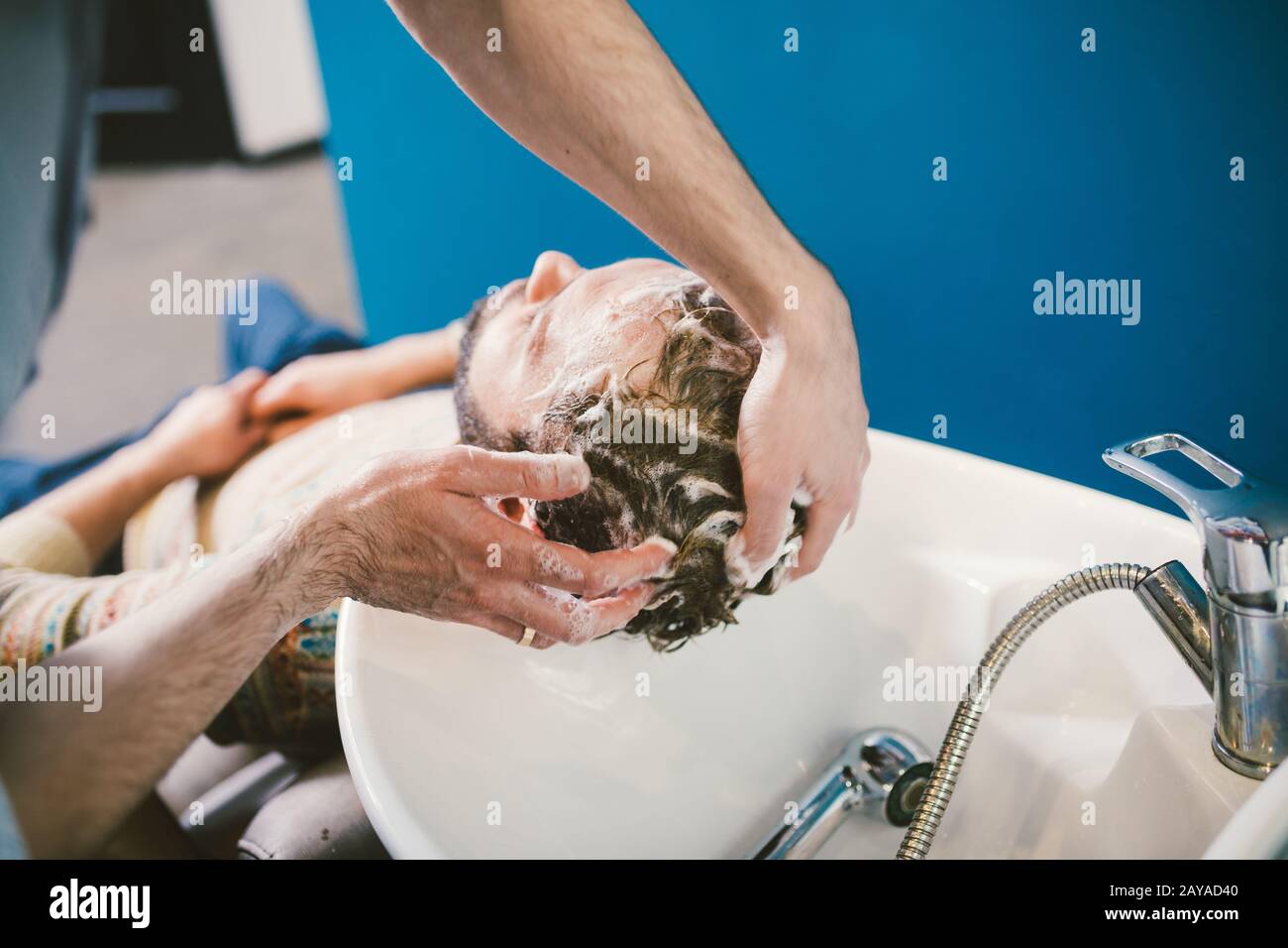 Barbershop theme. Hairdresser for washing hair in a barbershop. Hands ...