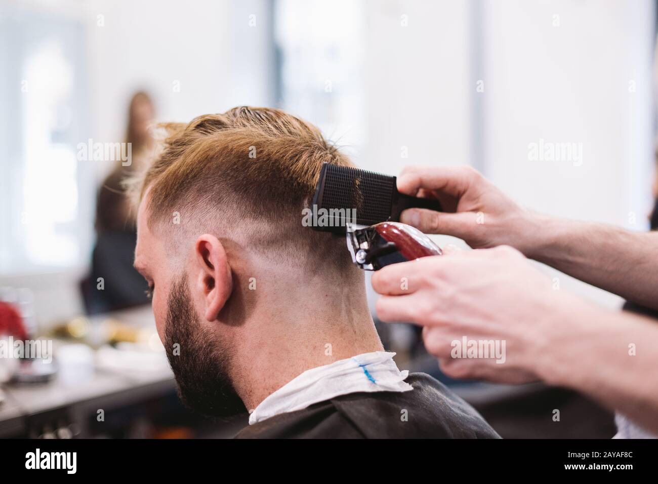 Barber making haircut using machine hi-res stock photography and images ...
