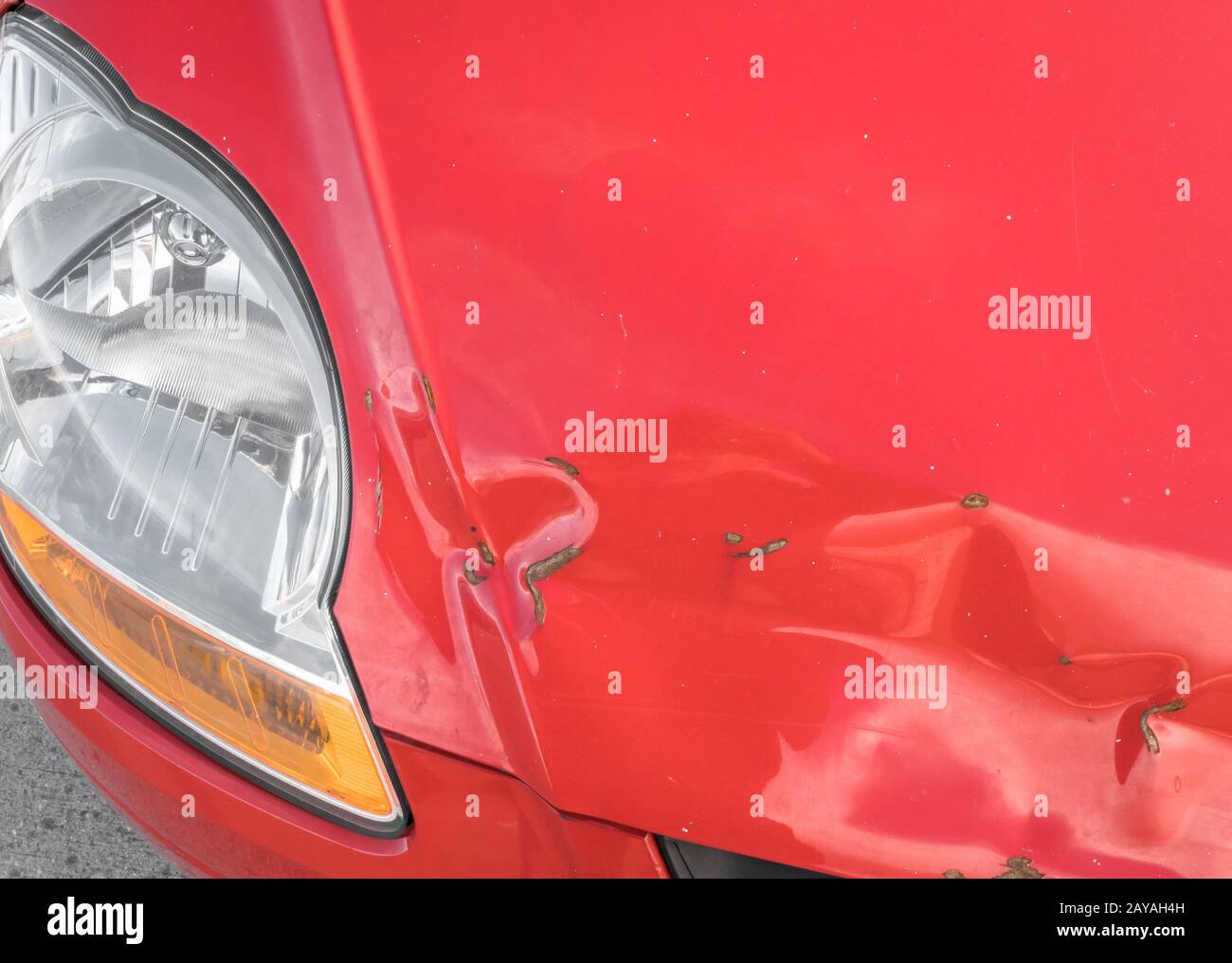 Scratches and rusty dent on front of red car Stock Photo - Alamy