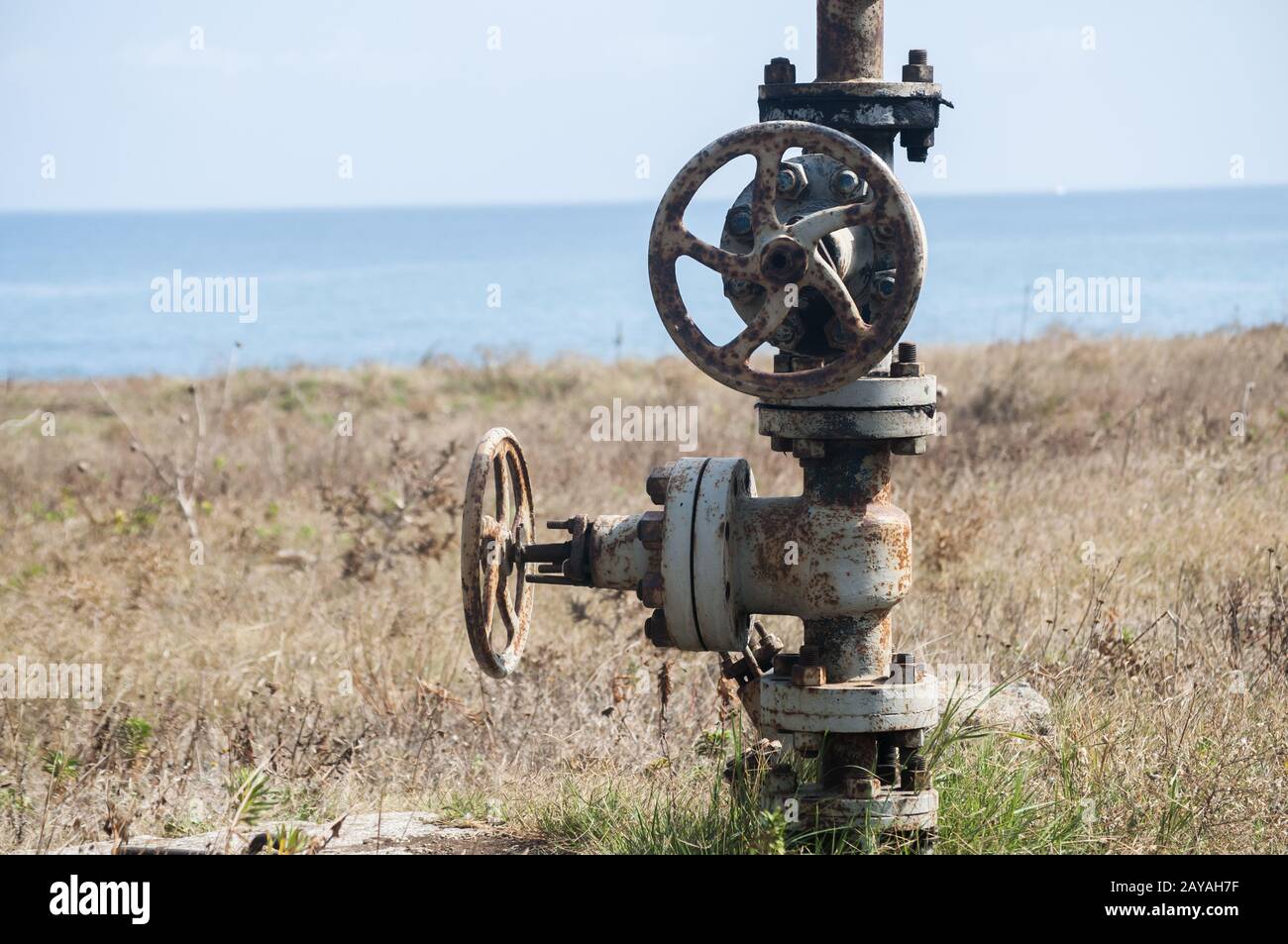 Old rusty weathered aged valve of abandoned pipe system equipment ...